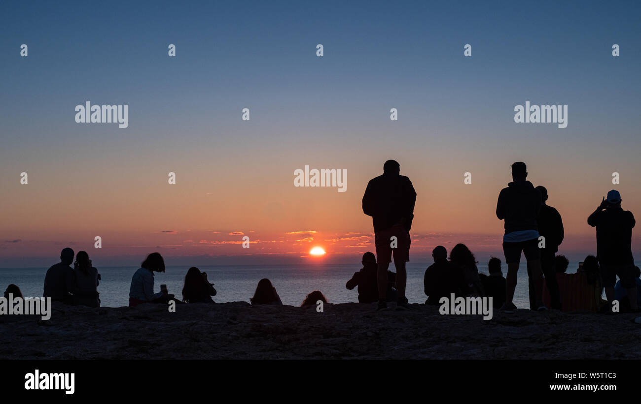 Group people sitting on cliff hi-res stock photography and images - Alamy