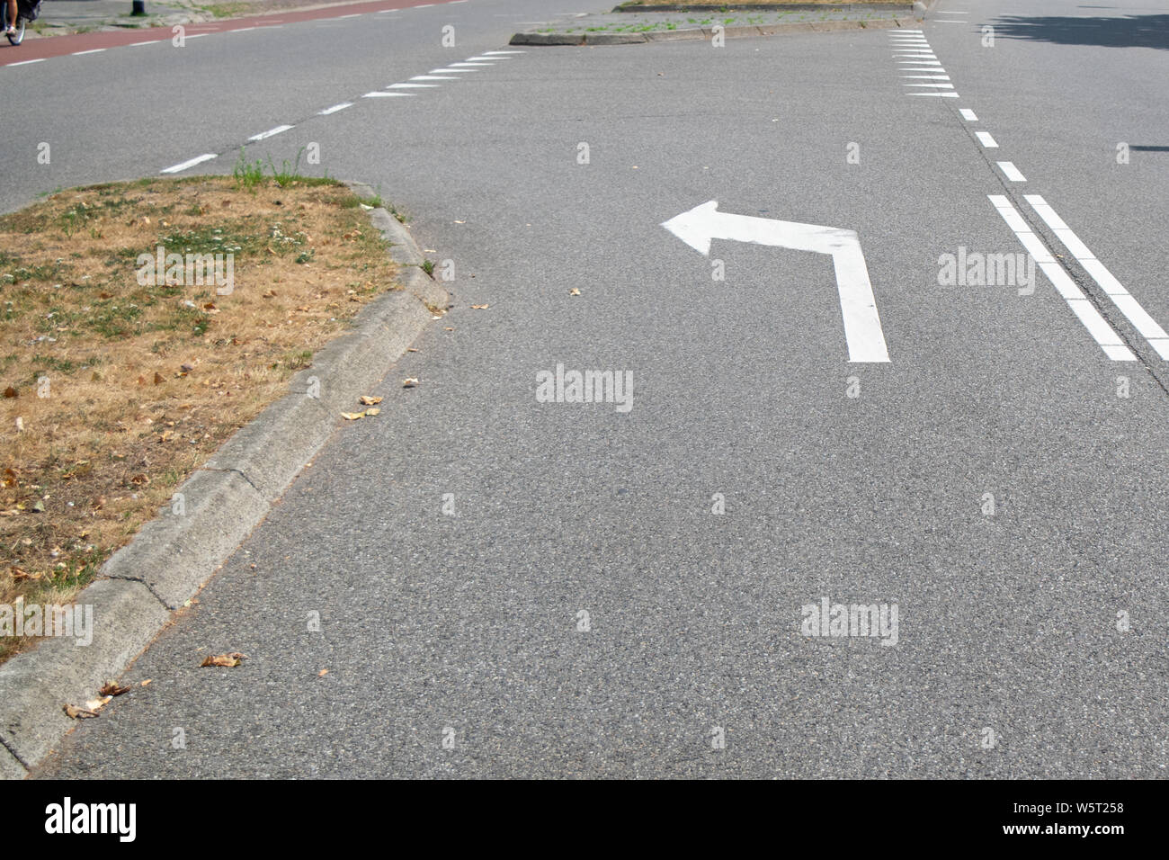 Left arrow way marking on the road Stock Photo - Alamy