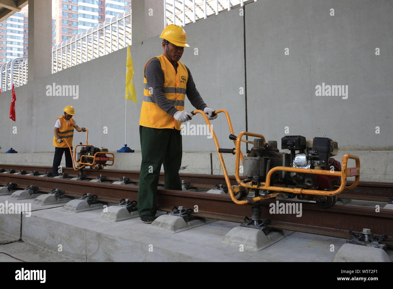 Chinese workers lay the tracks for the Beijing-Zhangjiakou high-speed ...