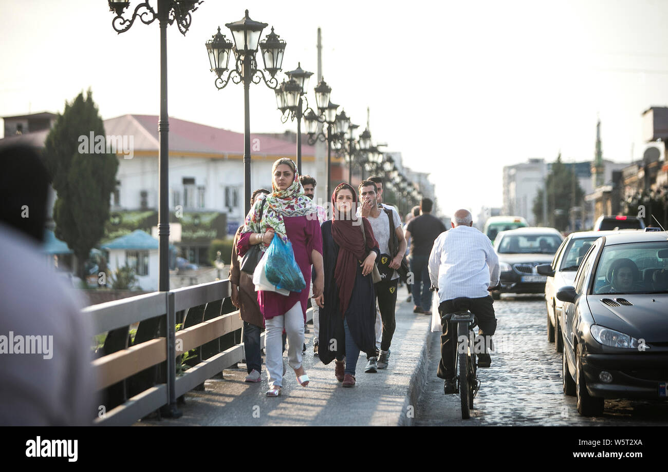 Tonekabon, Iran. 29th July, 2019. People walk on a bridge in Tonekabon ...