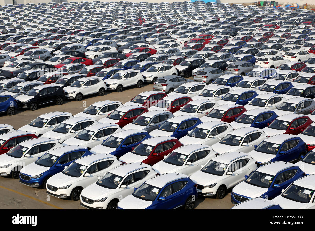 Exported vehicles to be shipped to abroad are lined up on the quay of a ...
