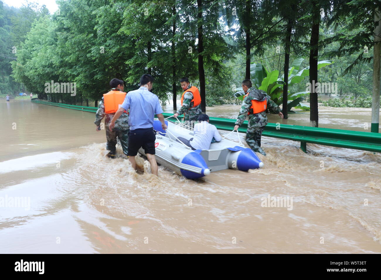 Chinese rescuers evacuate local residents in floodwater caused by a ...