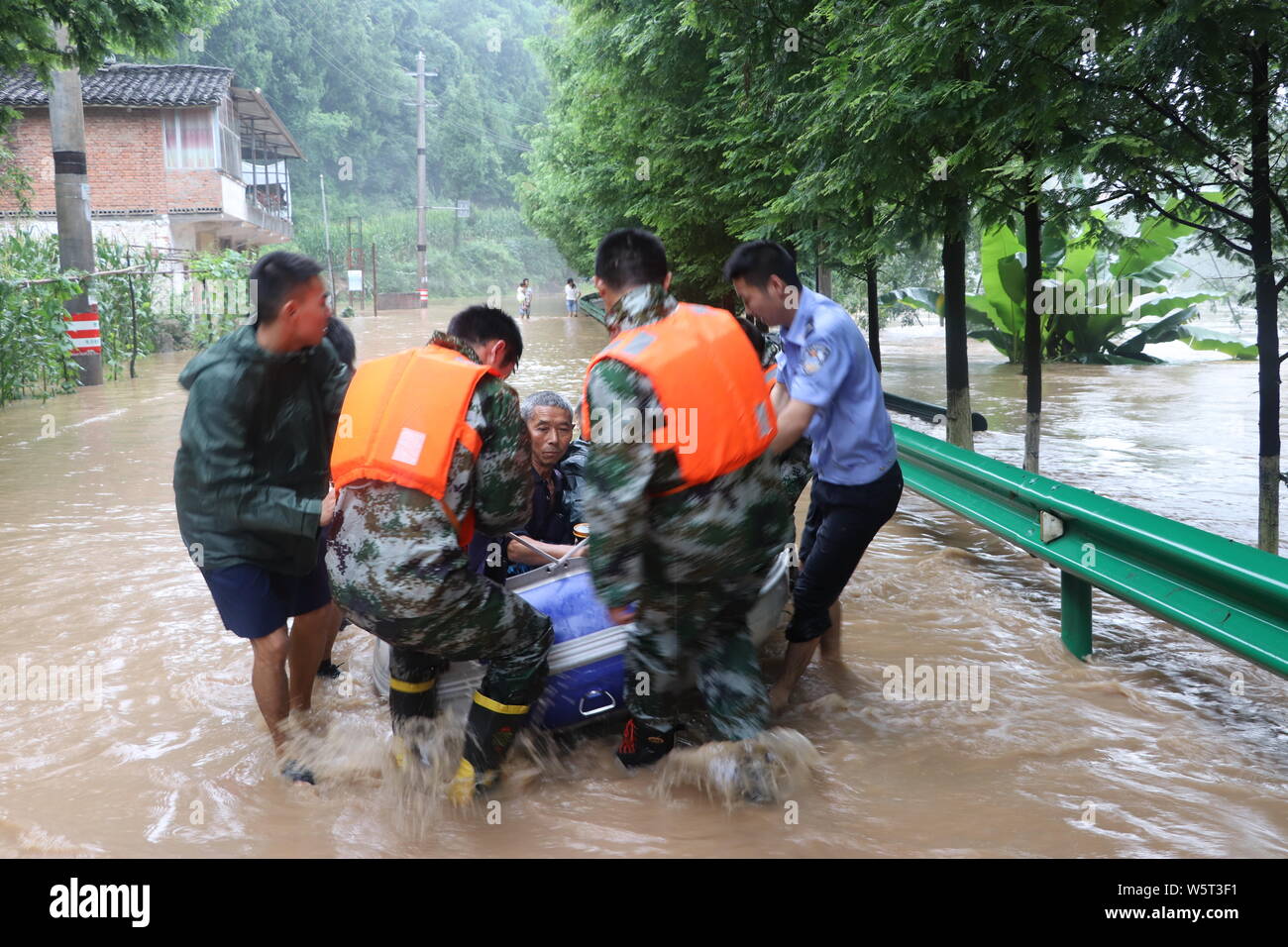 Chinese rescuers evacuate local residents in floodwater caused by a ...