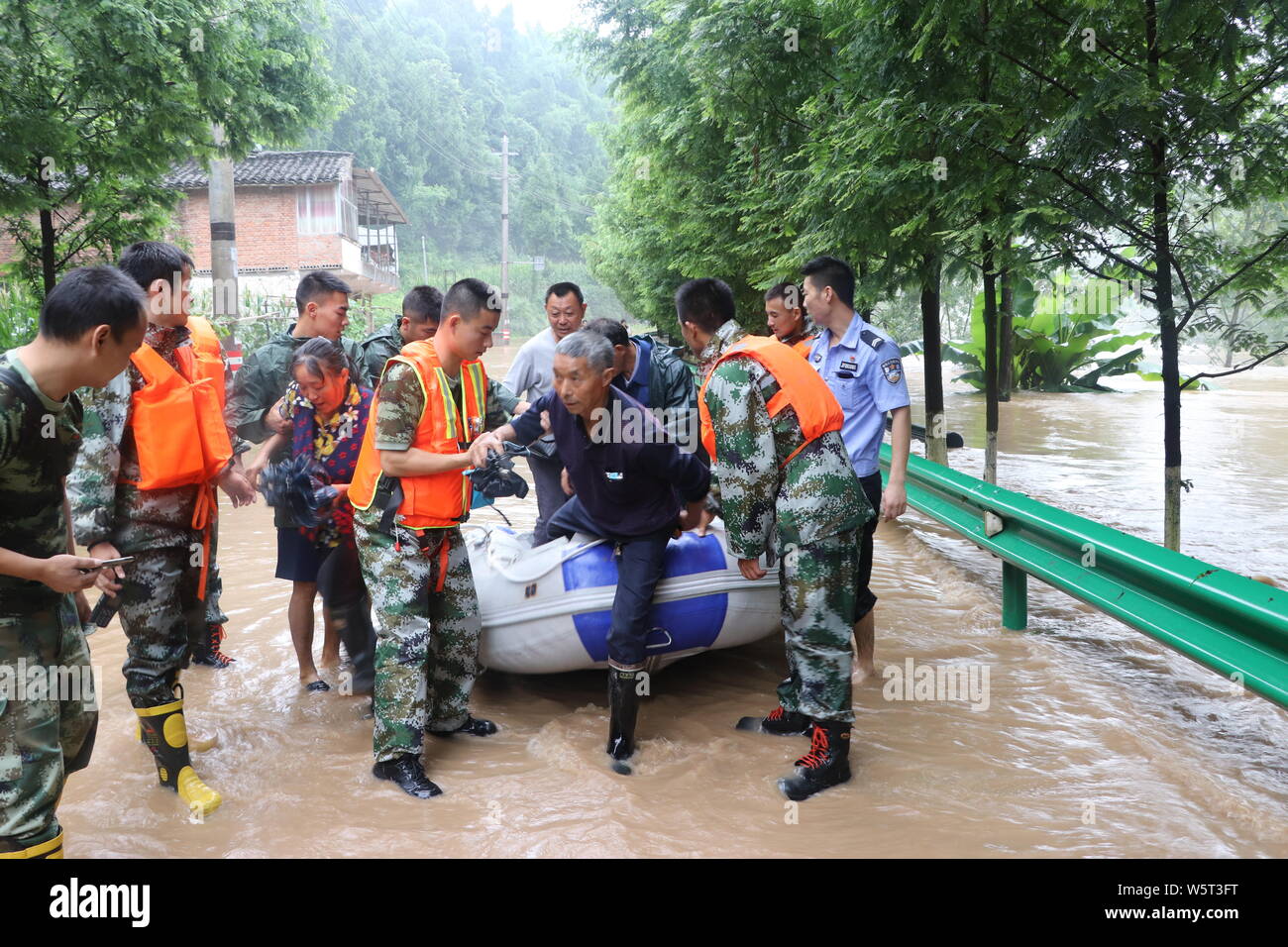 Chinese rescuers evacuate local residents in floodwater caused by a ...