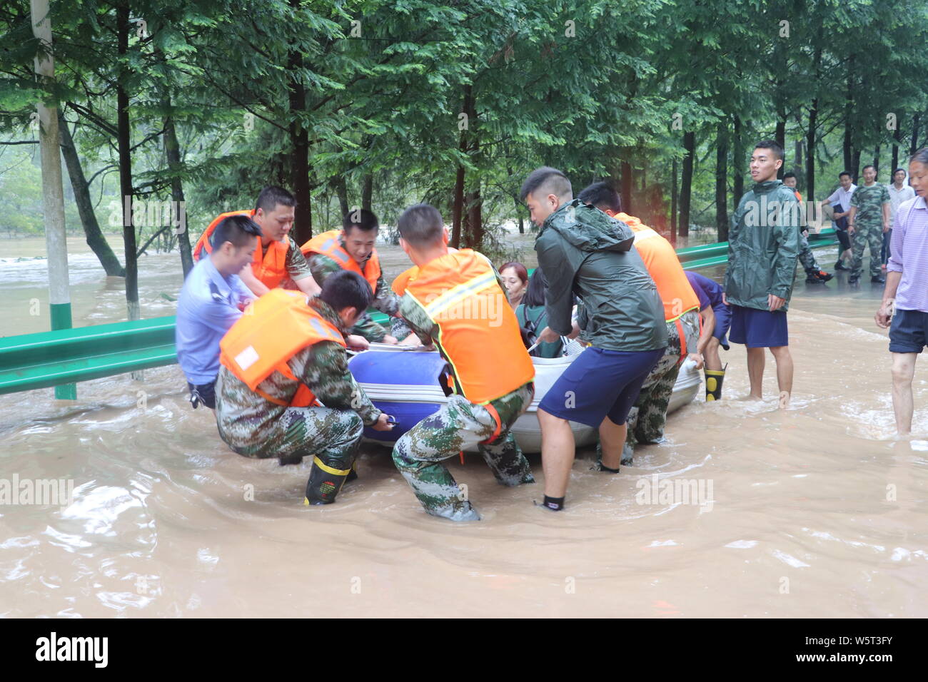 Chinese rescuers evacuate local residents in floodwater caused by a ...