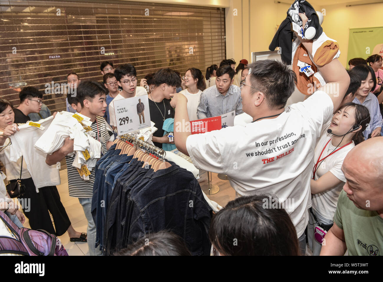 Chinese customers queue up in front of a Uniqlo store to buy the ...