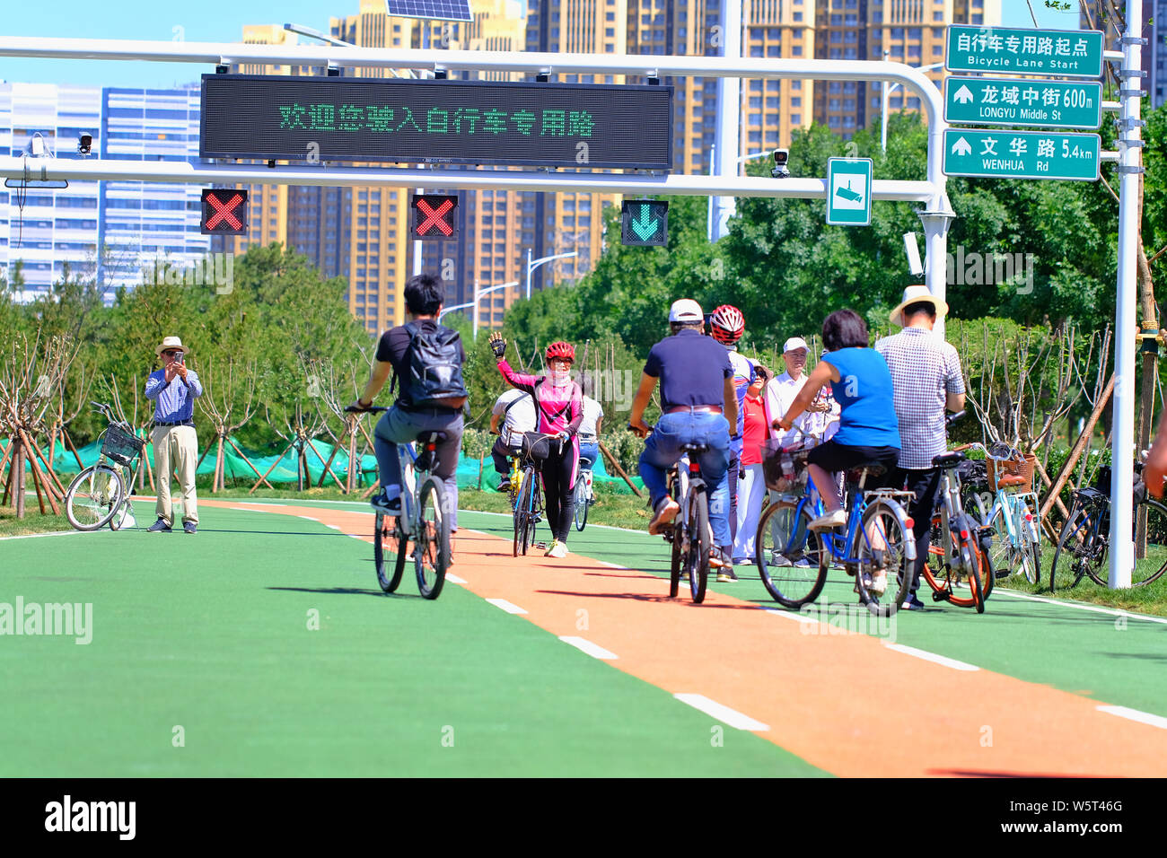 Local residents ride bikes on the first bicycle-only road, which is ...