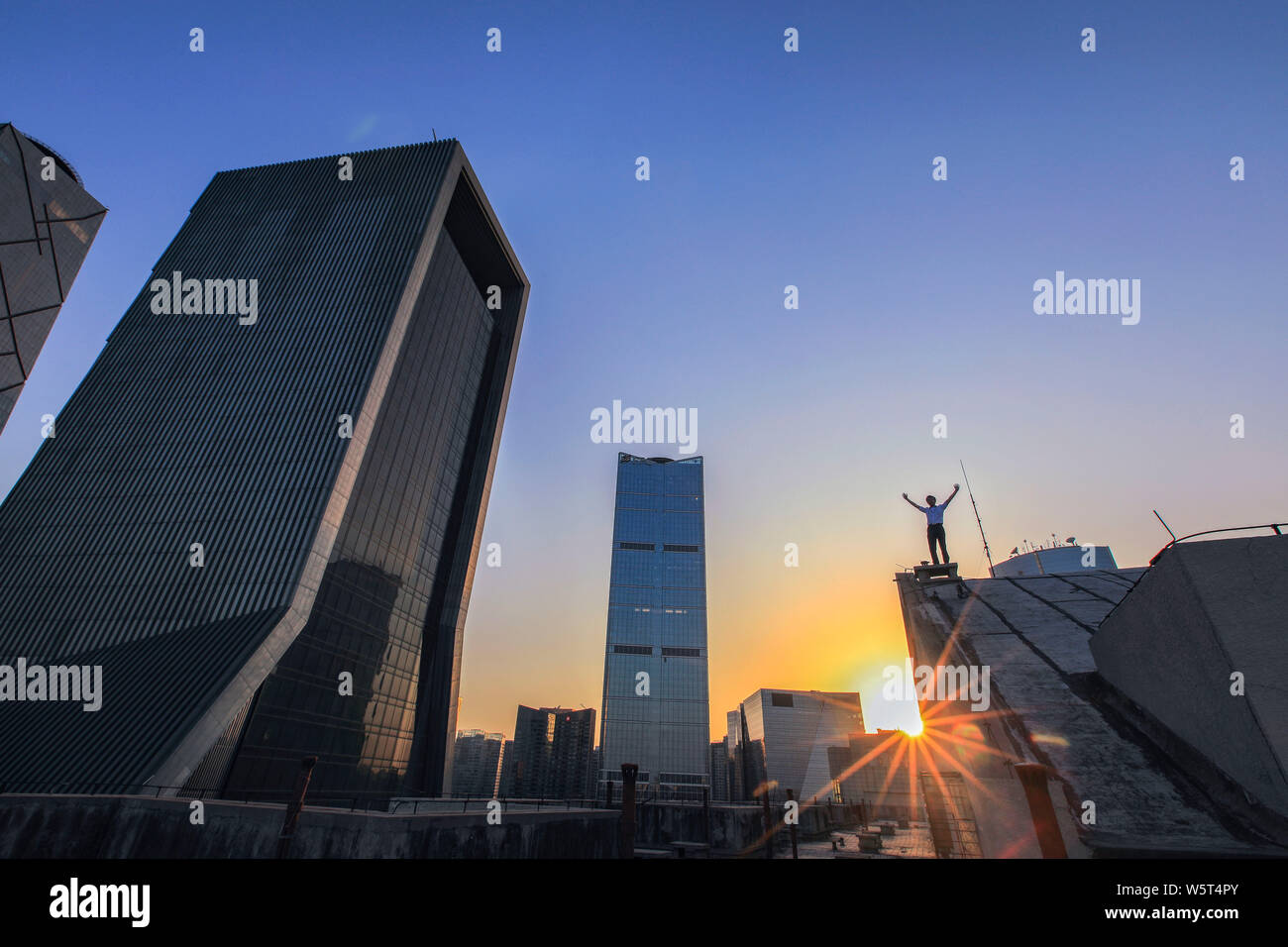 A Chinese photographer poses on the rooftop of a high-rise building in ...