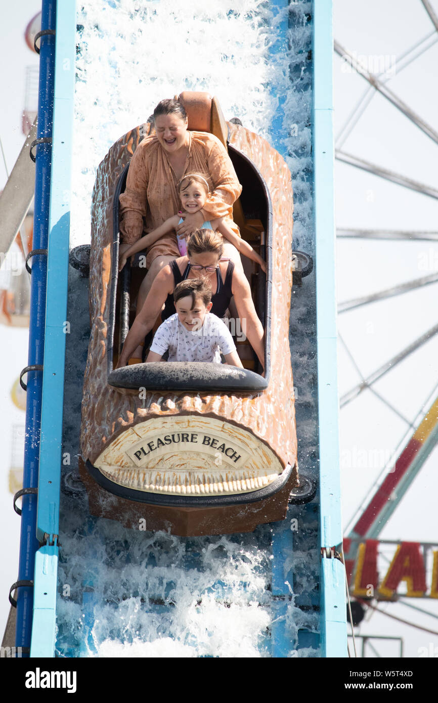 Hot weather in Skegness. People on the log water flume on Skegness ...