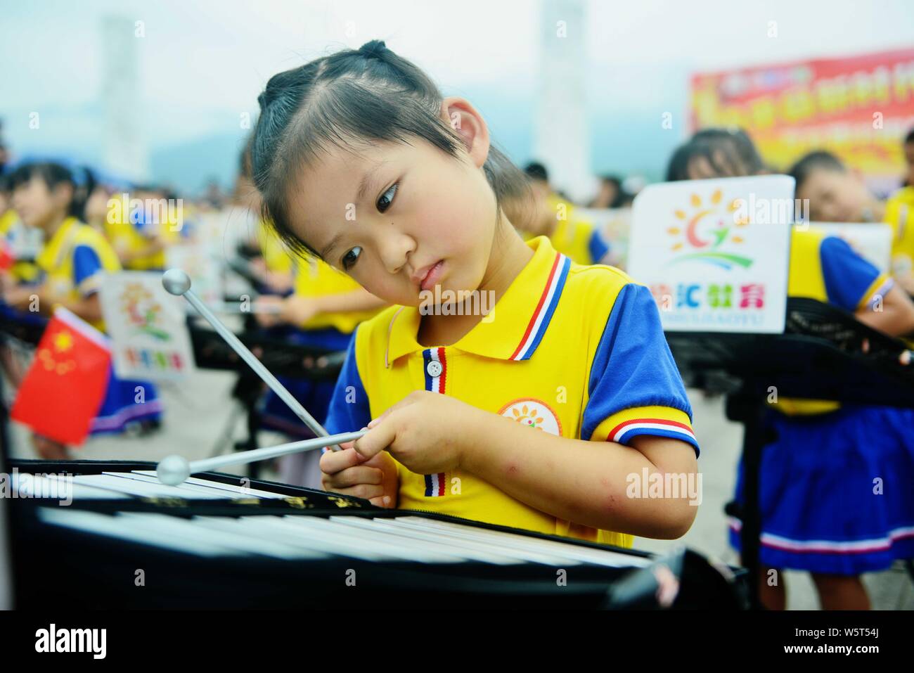 Chinese kids from a kindergarten play the glockenspiel to celebrate ...