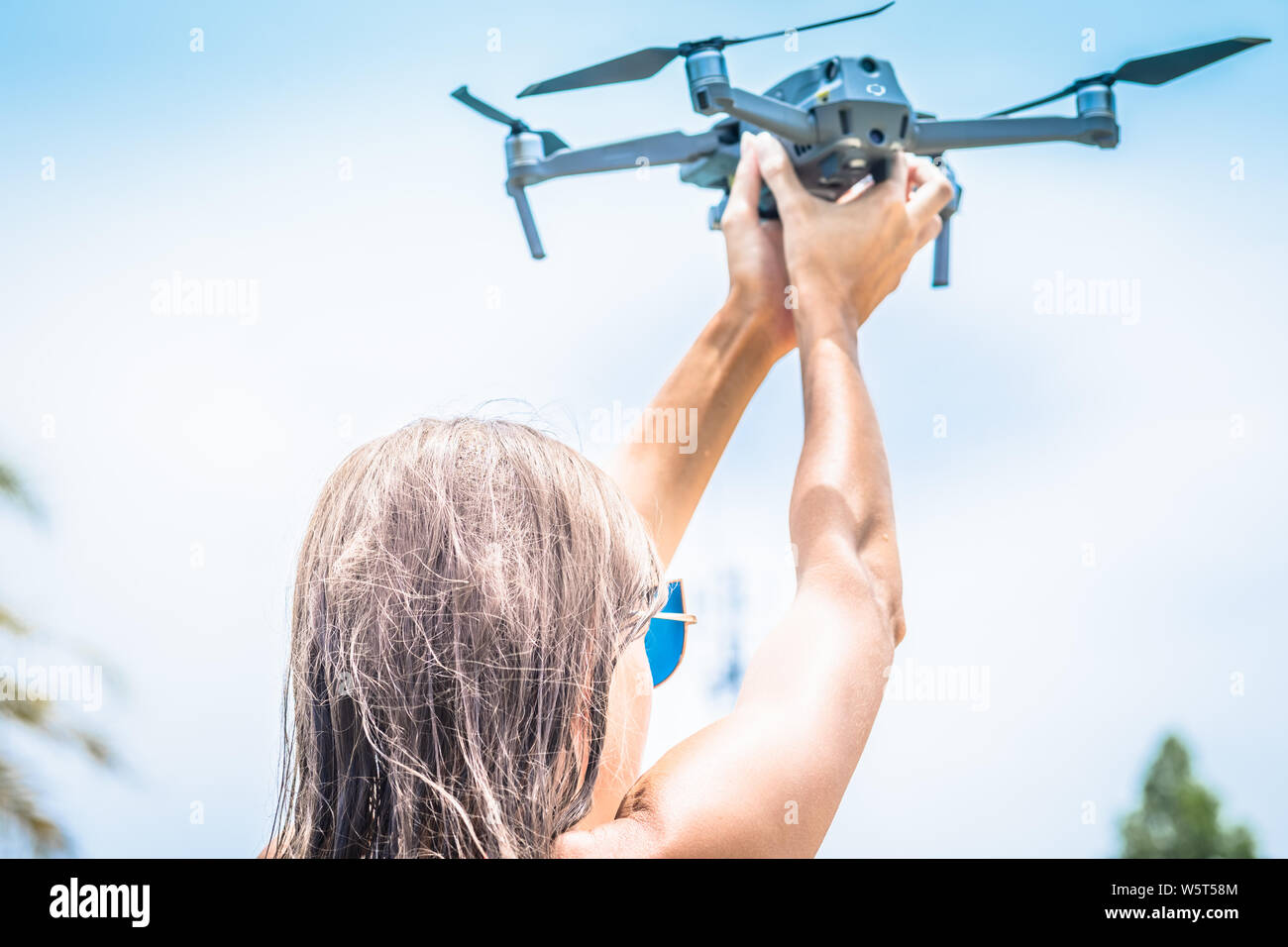Female hand launches drone for flight, with which you can take photos ...