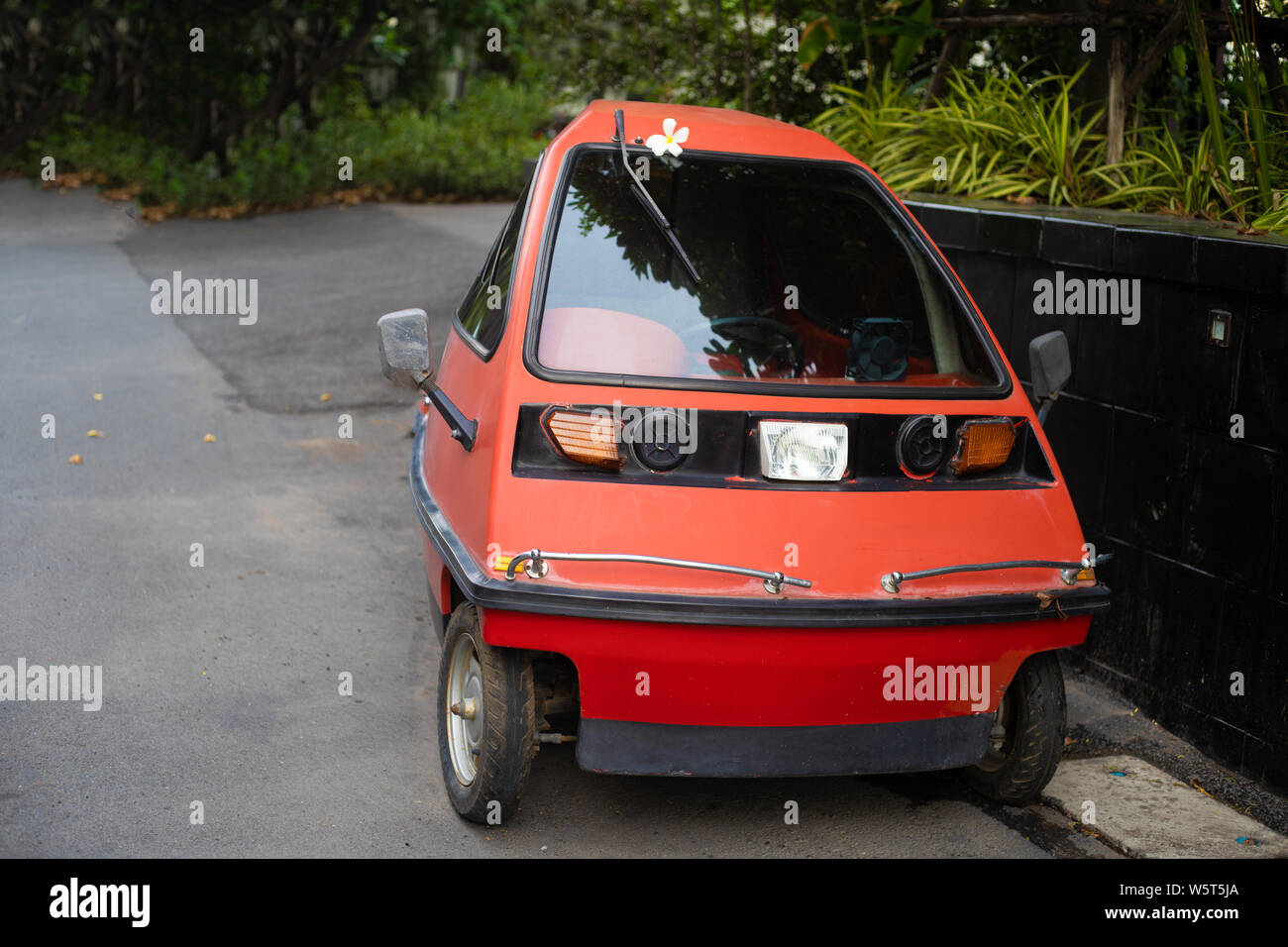 Funny red three-wheeled light car on the street of Pattaya Thailand ...