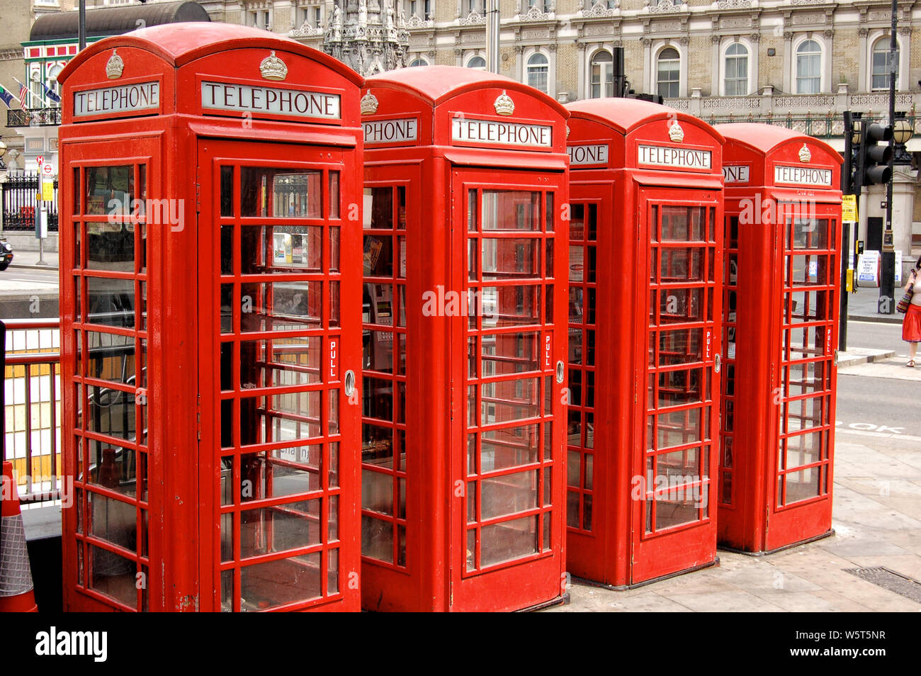 Four famous english red phone booth in the row Stock Photo - Alamy