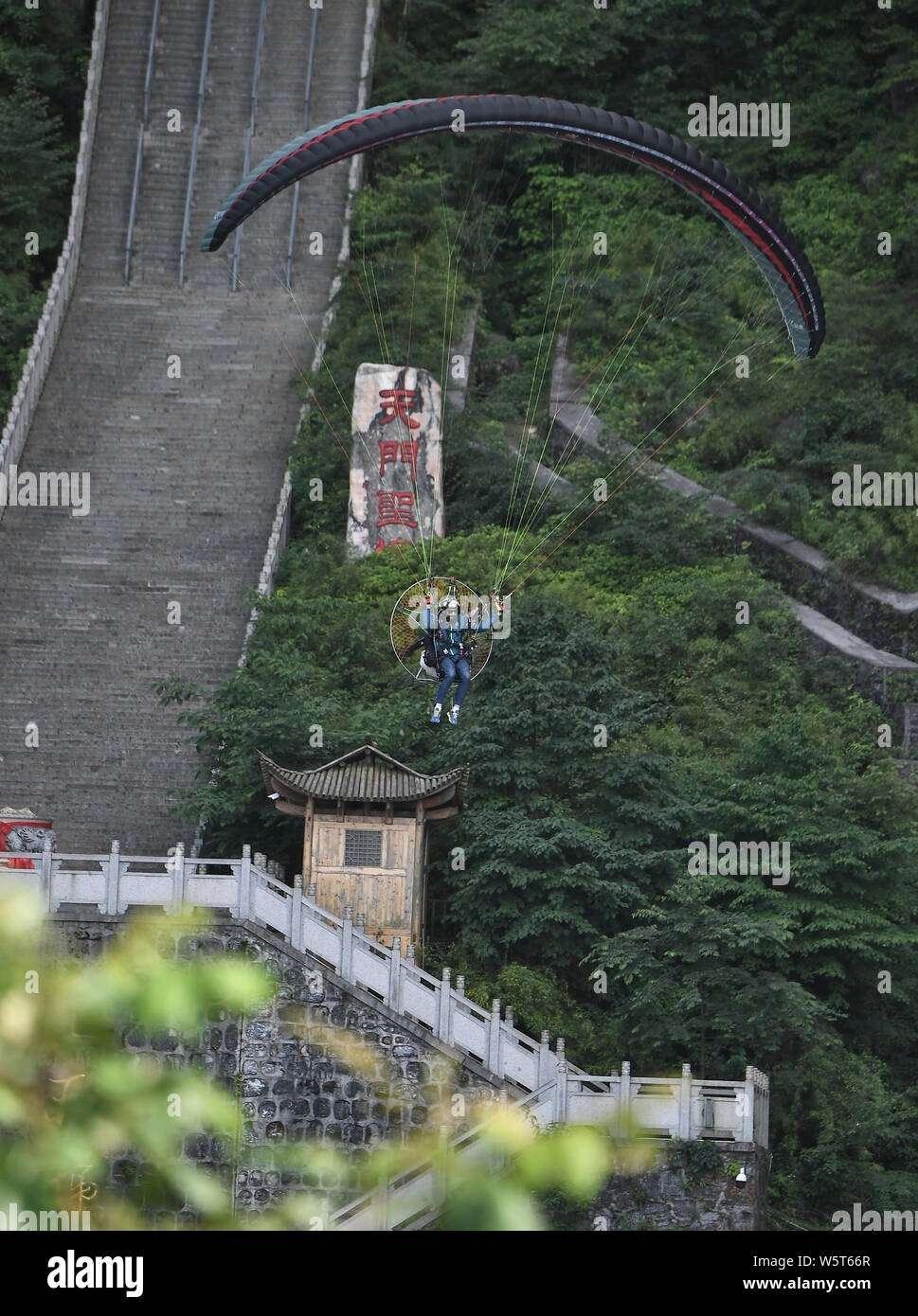 A wingsuit flyer jumps from a high place to glide through the air ...