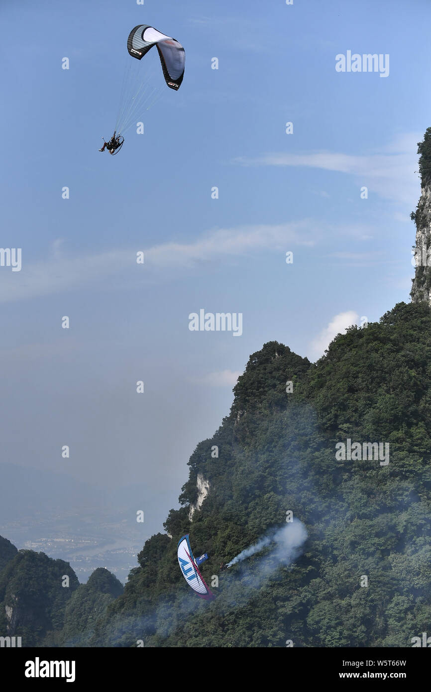 A wingsuit flyer jumps from a high place to glide through the air ...