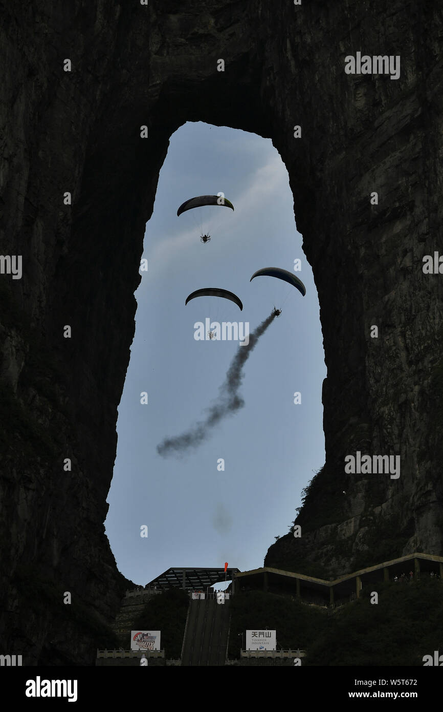 A wingsuit flyer jumps from a high place to glide through the air ...
