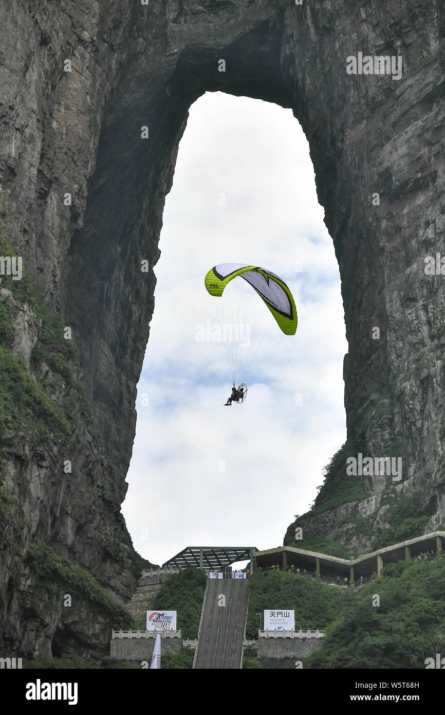 A wingsuit flyer jumps from a high place to glide through the air ...