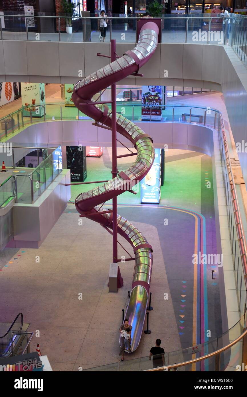 Young Chinese kids try out the three-storey-high spiral slide at a ...