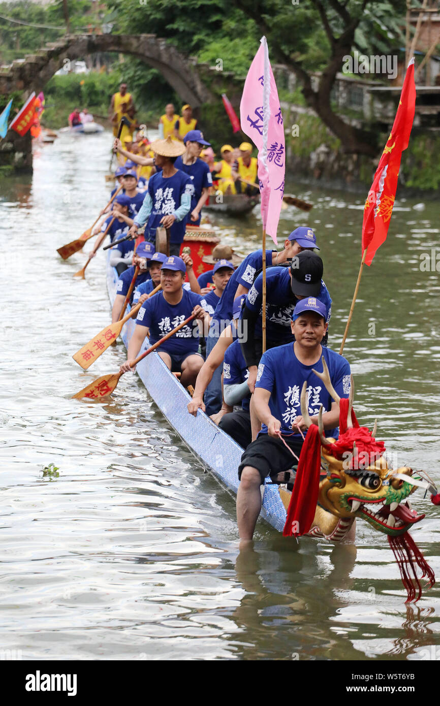Chinese participants row dragon boats during a festivity to celebrate ...