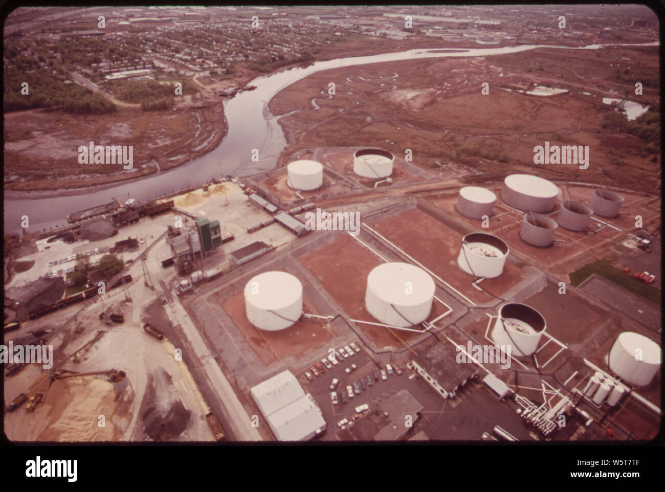 PHILLIPS PETROLEUM COMPANY STORAGE TANKS IN FOREGROUND TOWN OF CARTARET ...