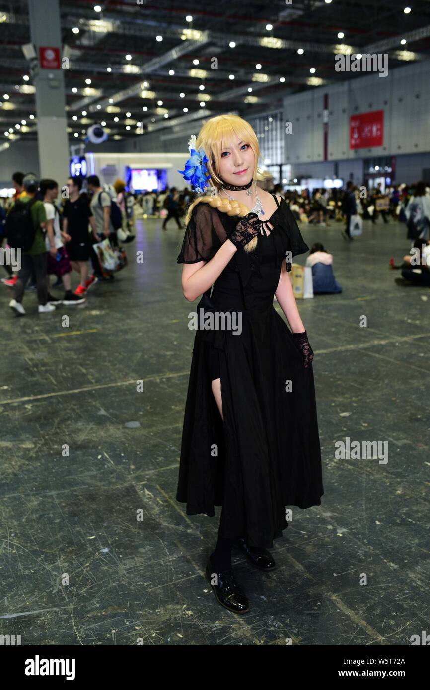An entertainer dressed in cosplay costume poses during the Shanghai ...