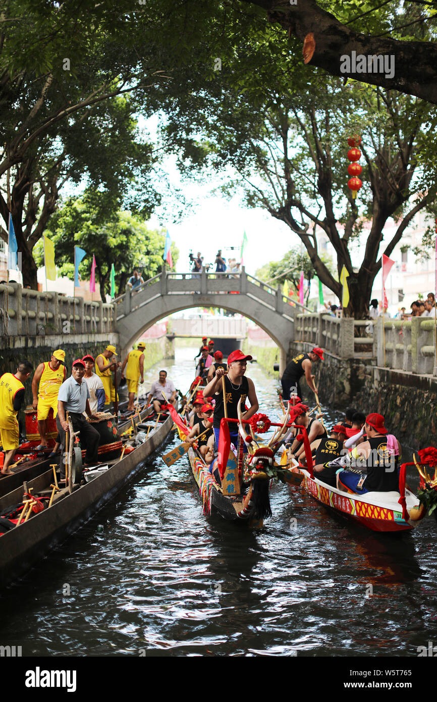 Chinese participants row dragon boats during a festivity to celebrate ...