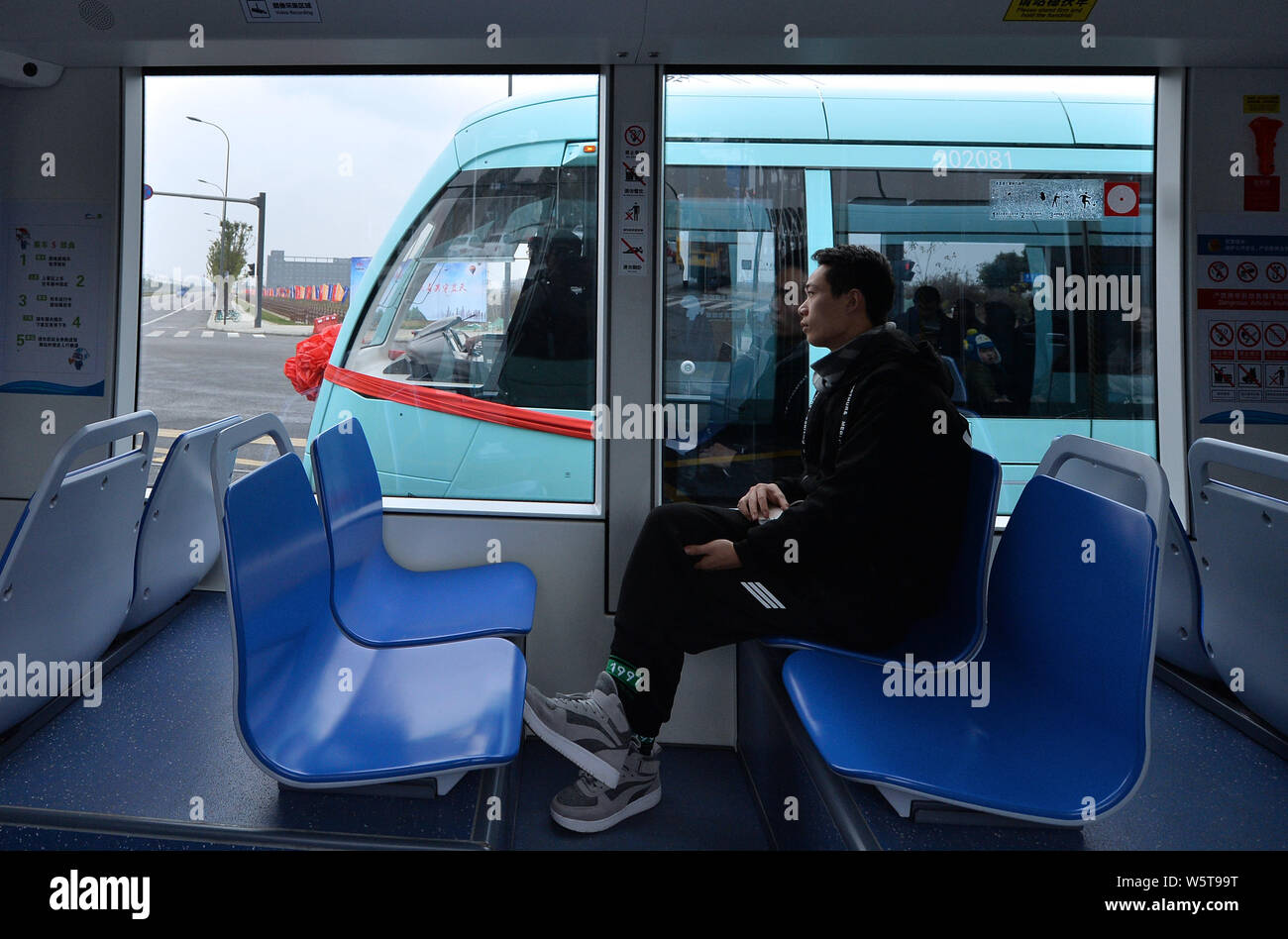 A passenger sits in a tramcar on city's second tram line, Rong tram ...