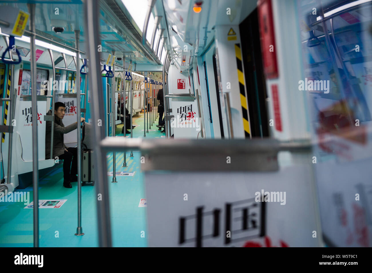 Chinese commuters sit in a themed subway train of Shenzhen Metro Line 1 ...