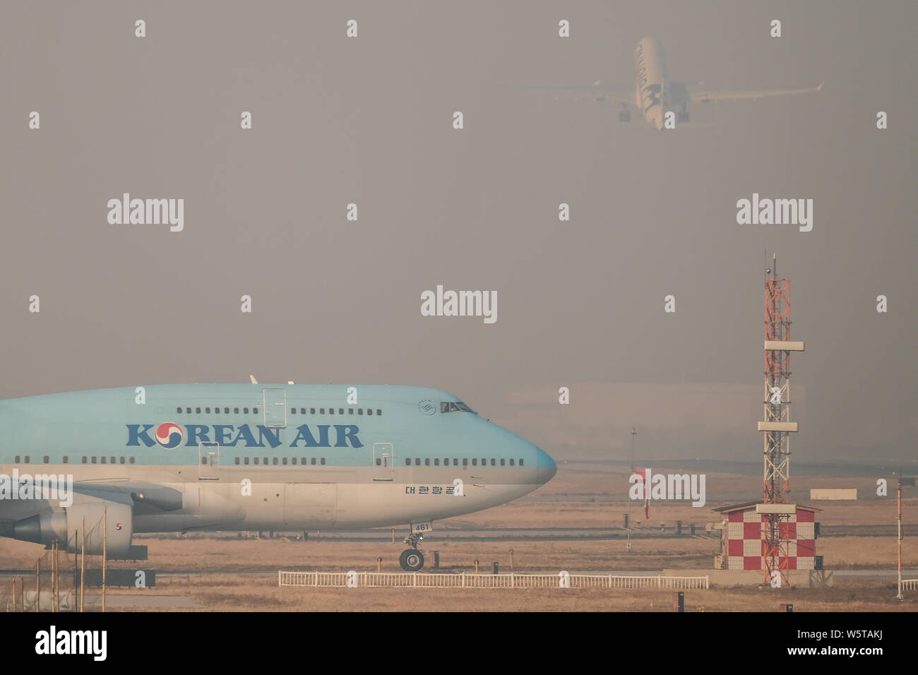 --FILE--A jet plane of Korean Air is pictured in heavy smog at the ...