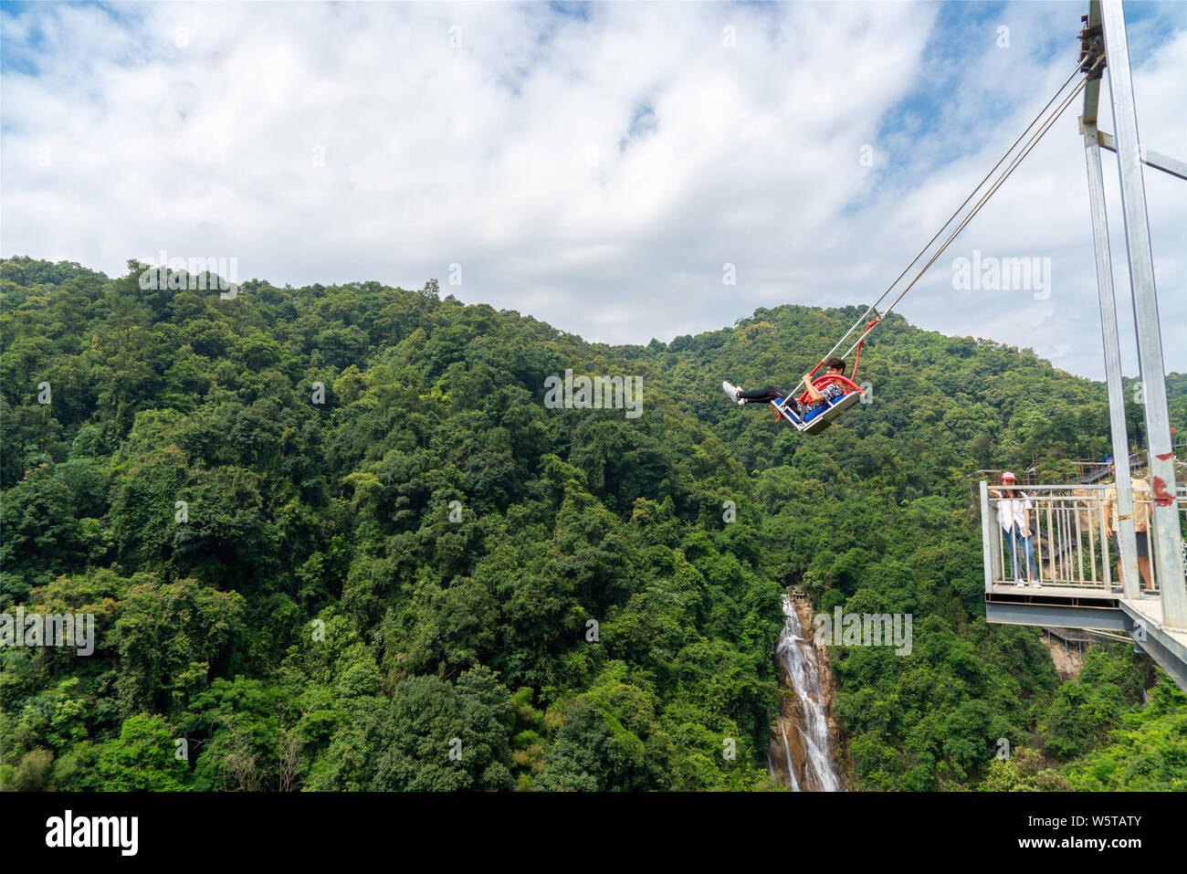 A visitor tries out 198-meter-high cliff swing, which is Guangdong's ...