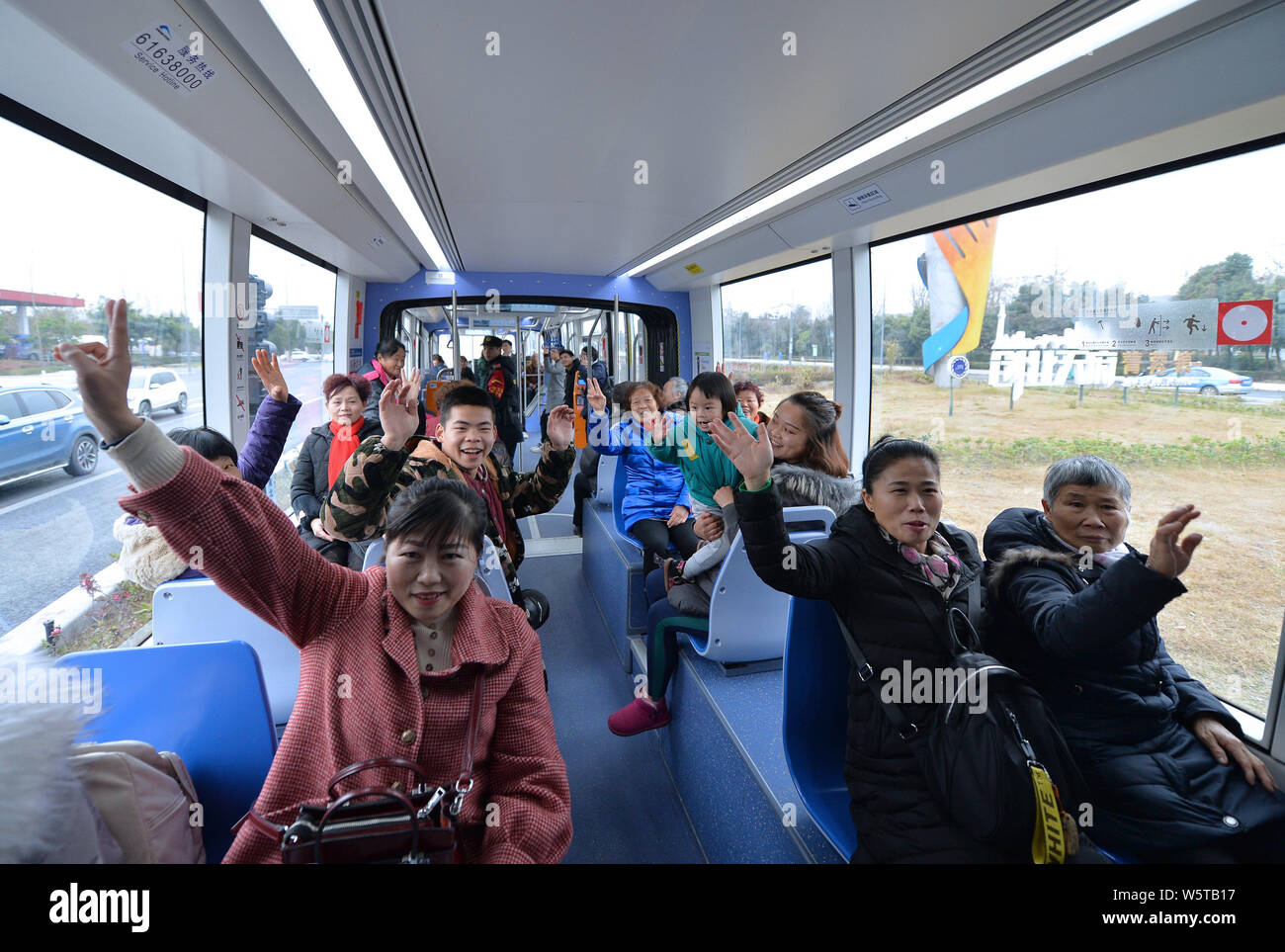 Passengers sit in a tramcar on city's second tram line, Rong tram line ...
