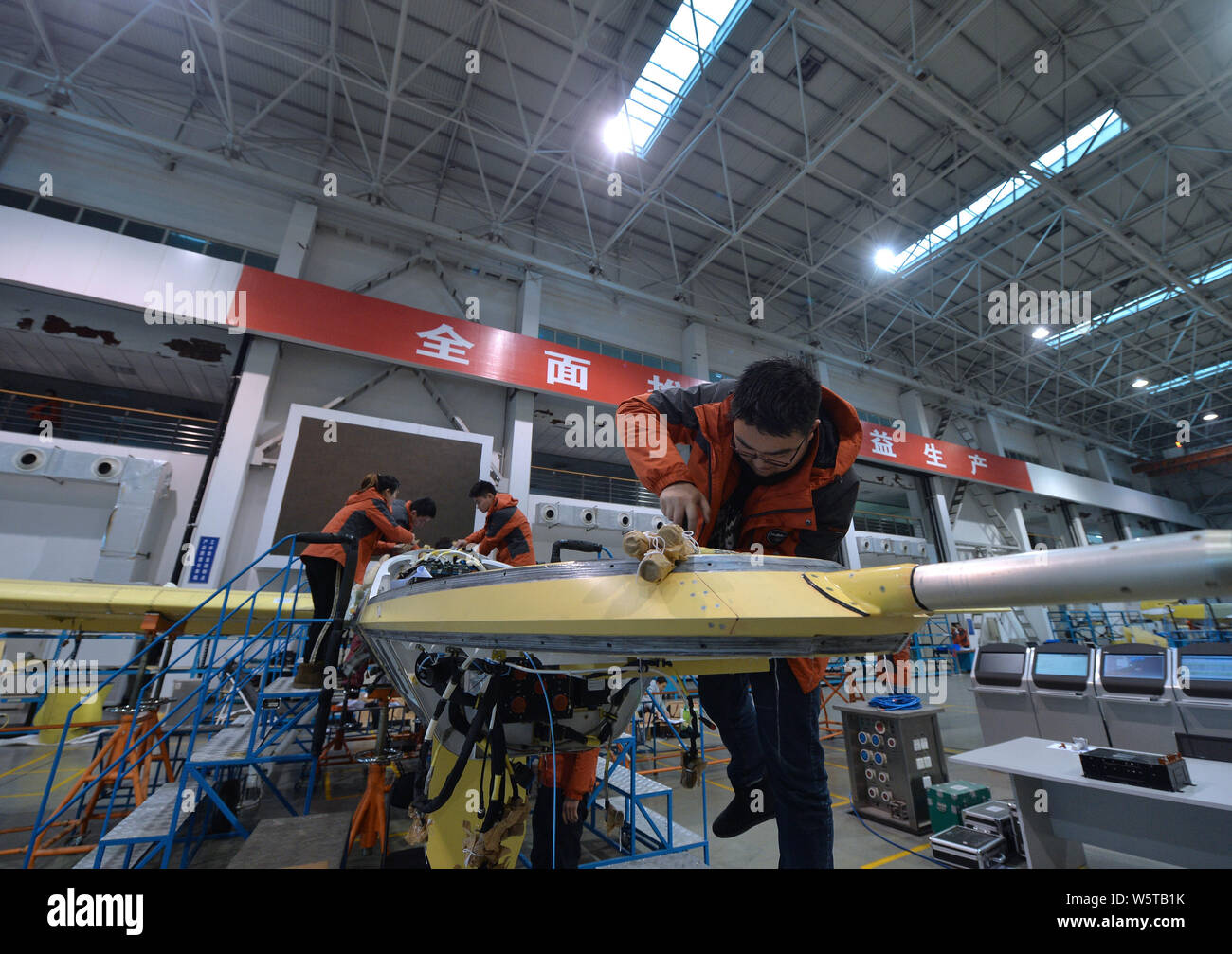 --FILE--Chinese workers assemble a Wing Loong unmanned aerial vehicle ...