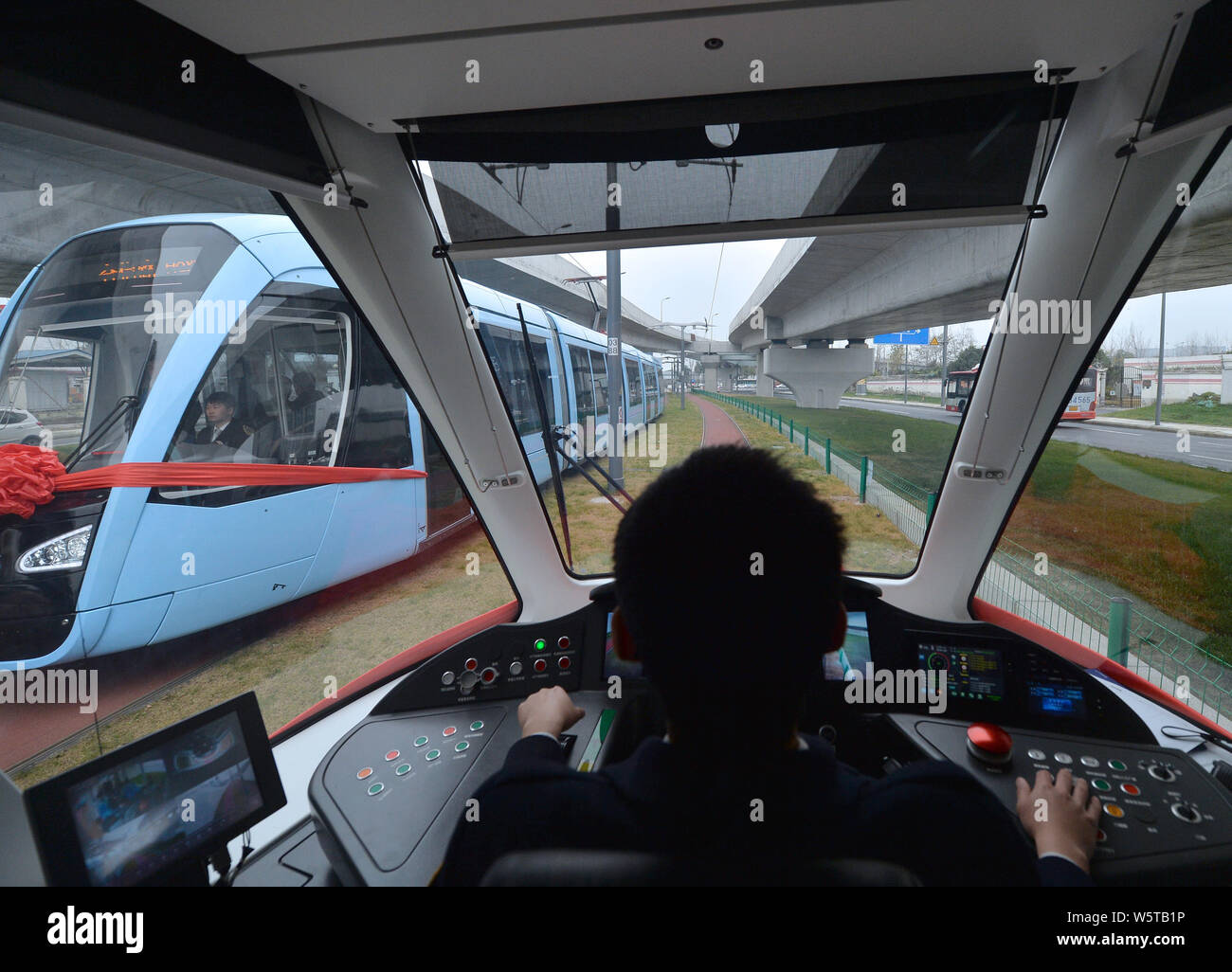 A driver operates a tramcar on city's second tram line, Rong tram line ...