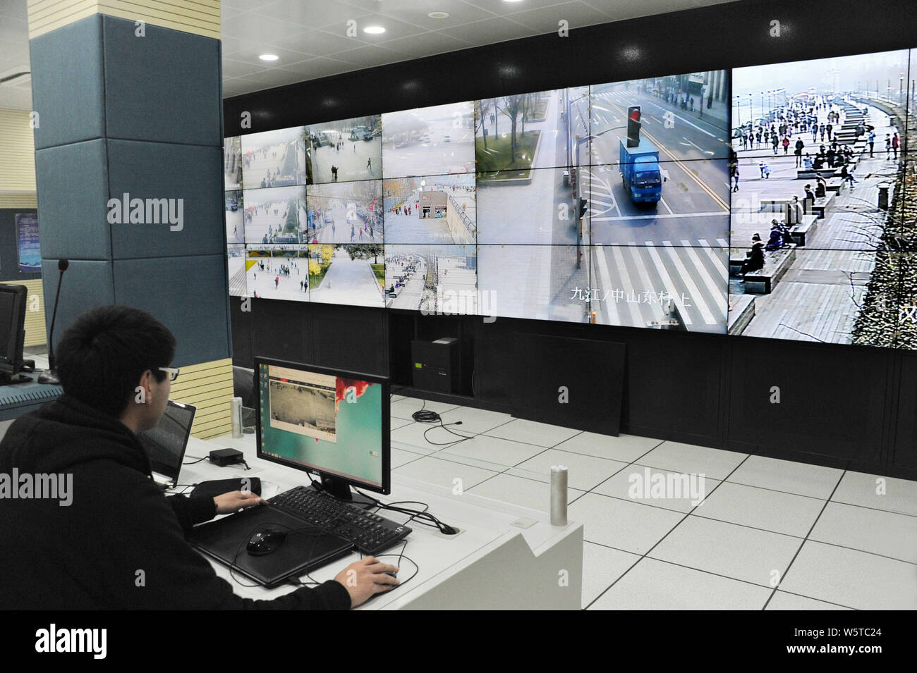 A Chinese worker watches screens to monitor the situation in the Bund ...