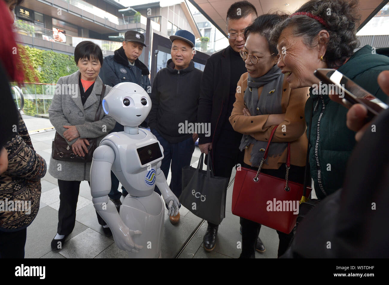 --FILE--An AI robot interacts with local residents in China's first 5G ...