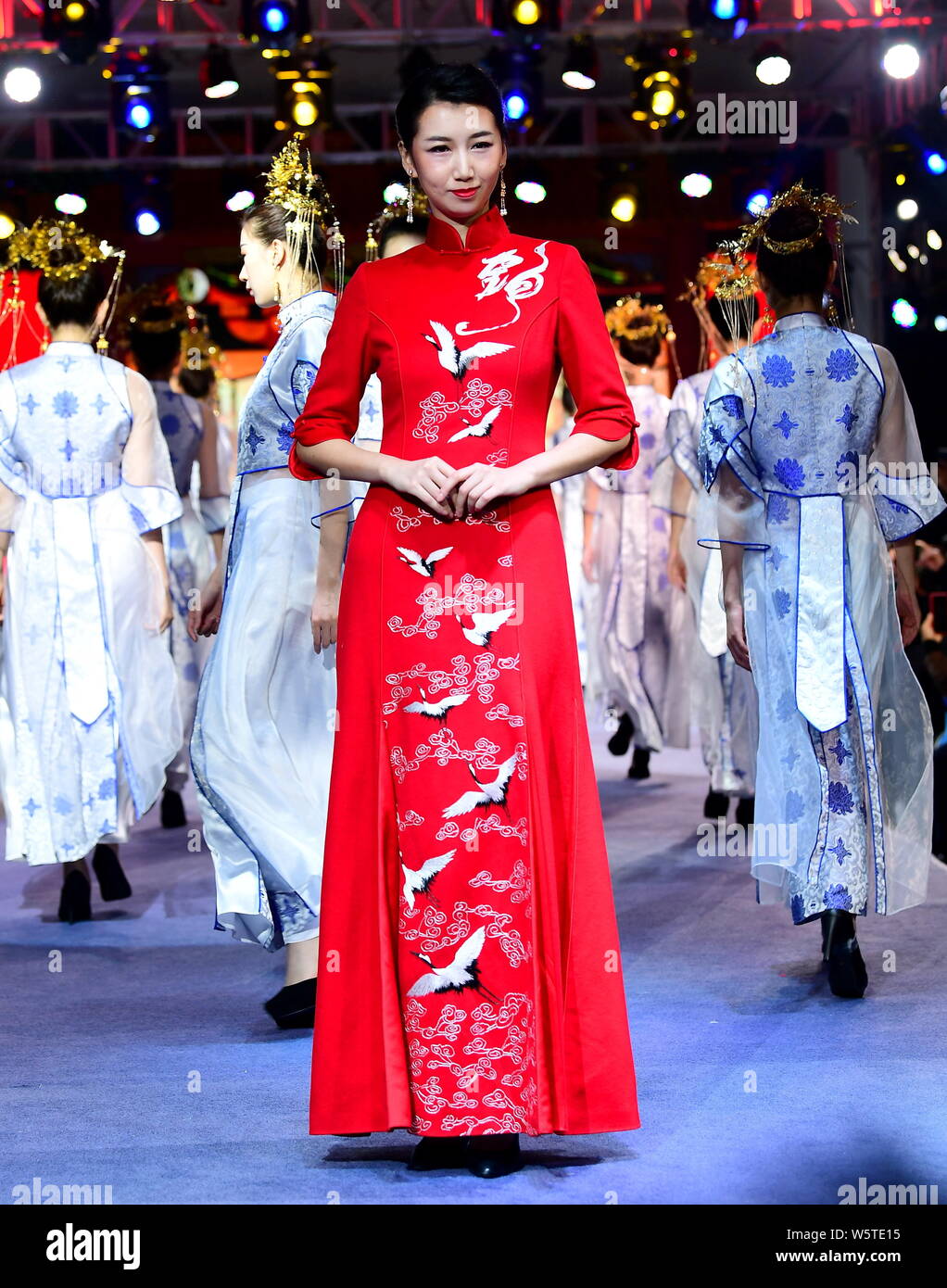 A model presents a new creation of cheongsam (qipao) made of ...