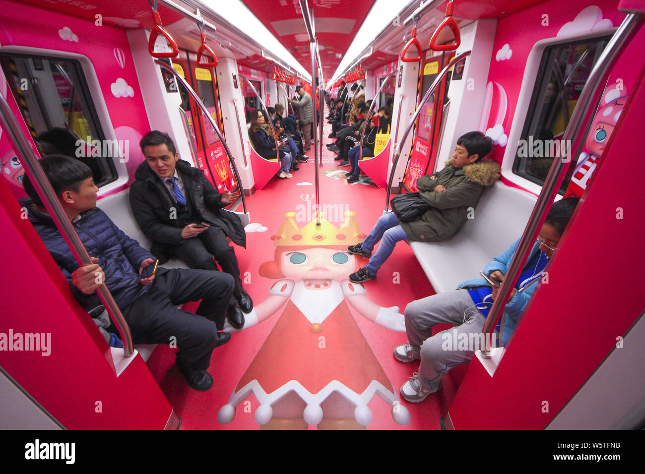 Passengers take a subway train decorated with Molly Fantasy ads in ...