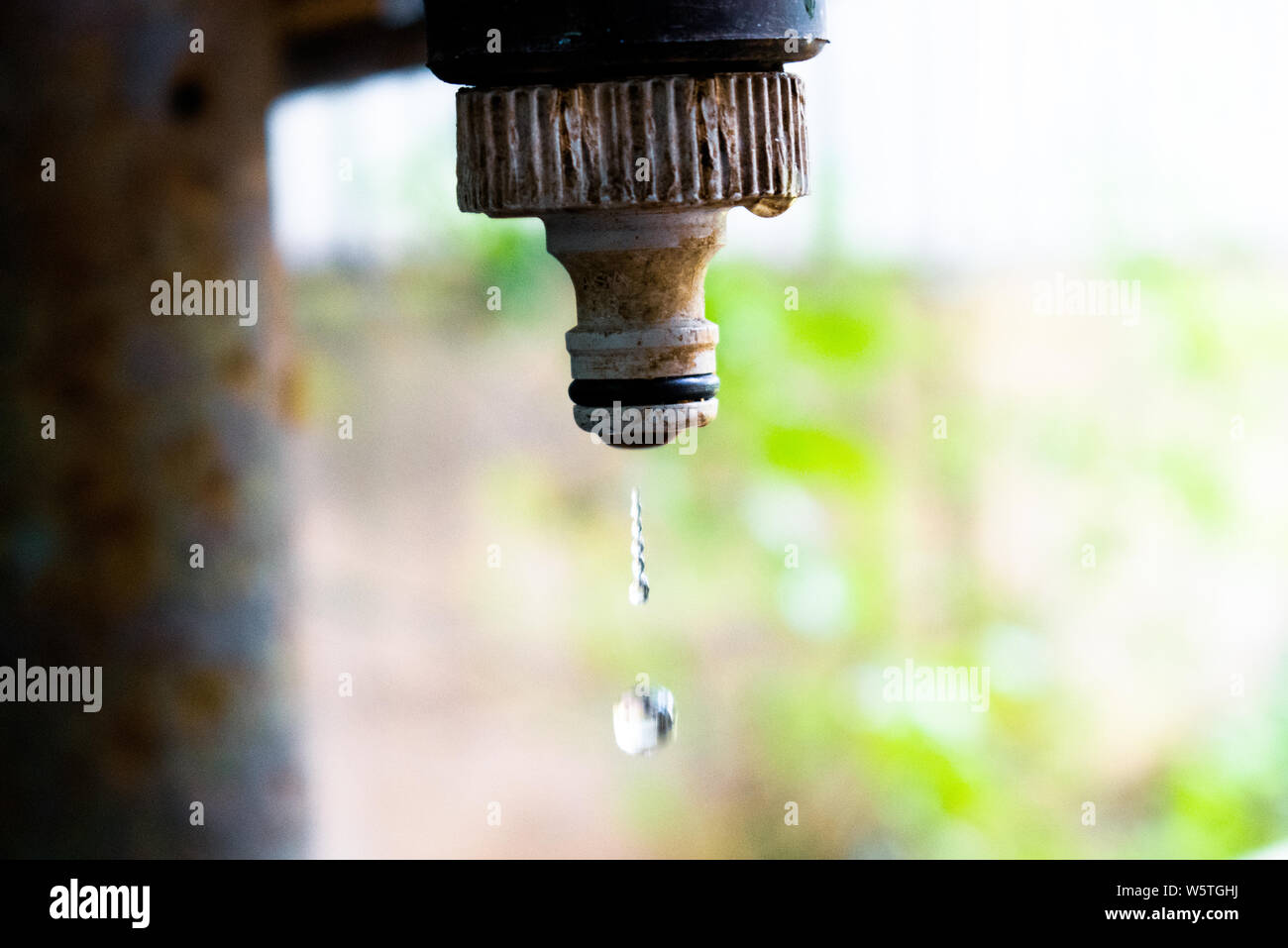 A water drop falls from a dirty and rusty water tap - Water engineering ...