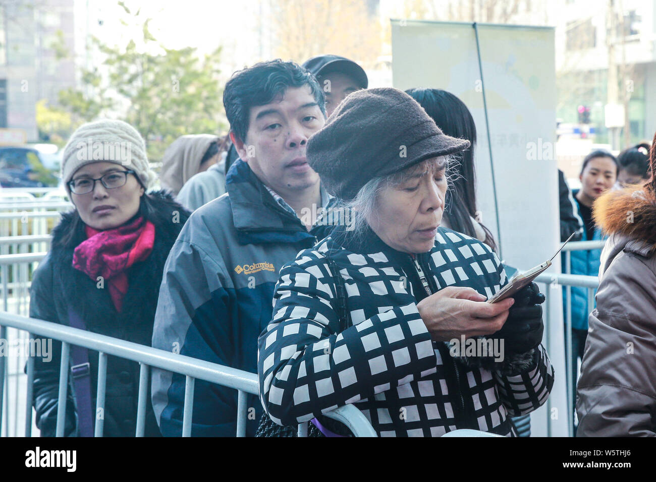 Chinese customers queue up outside the headquarters of the bike-sharing ...