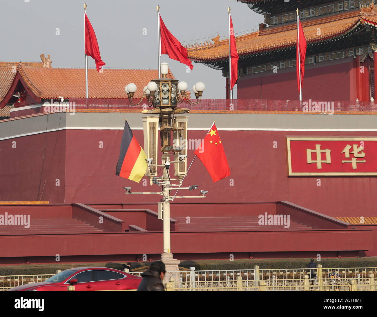 --FILE--Chinese and German national flags flutter on a lamppost in ...