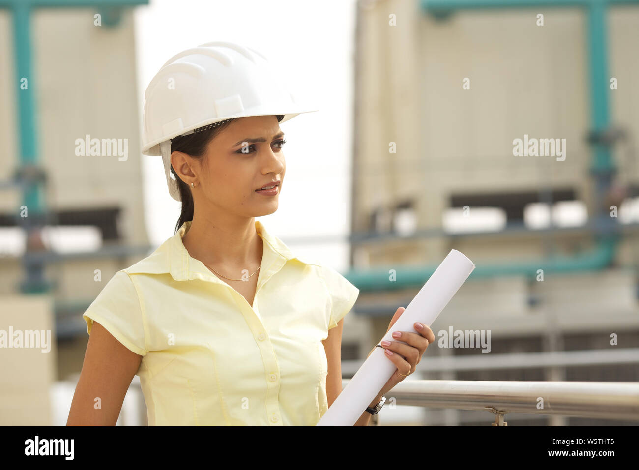 Architect holding blueprint at construction site Stock Photo - Alamy