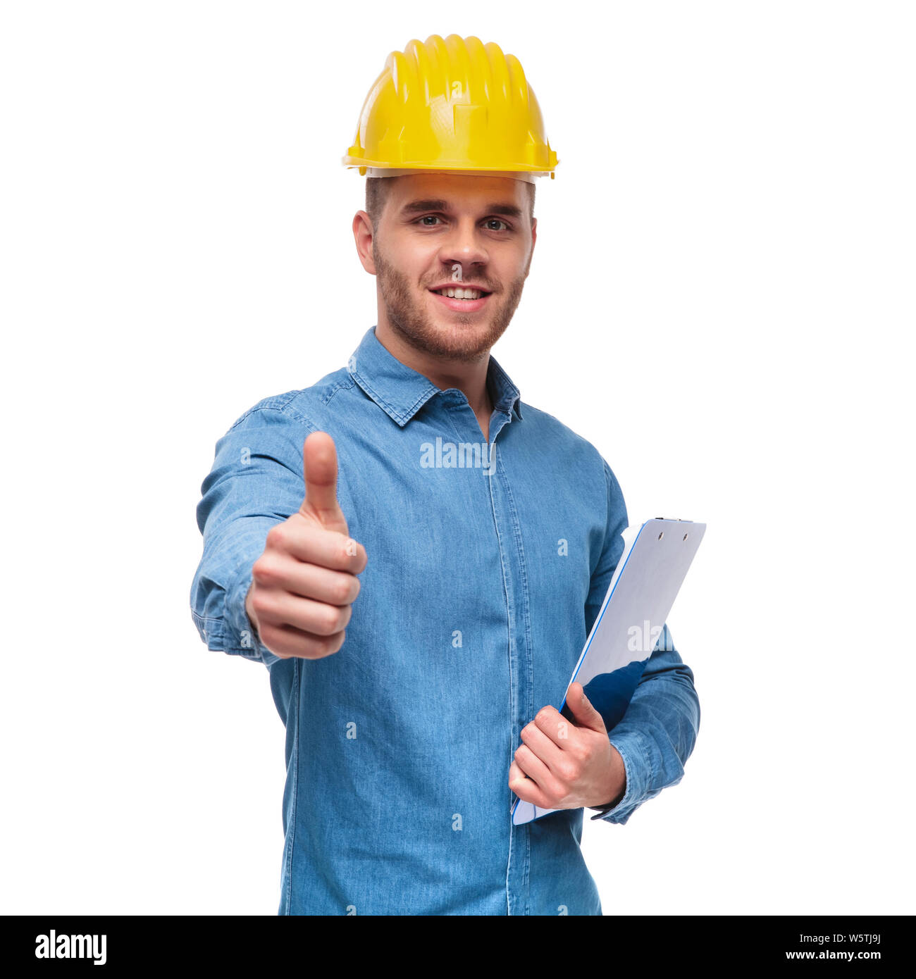 portrait of casual engineer with folders in hand makeing ok sign while ...