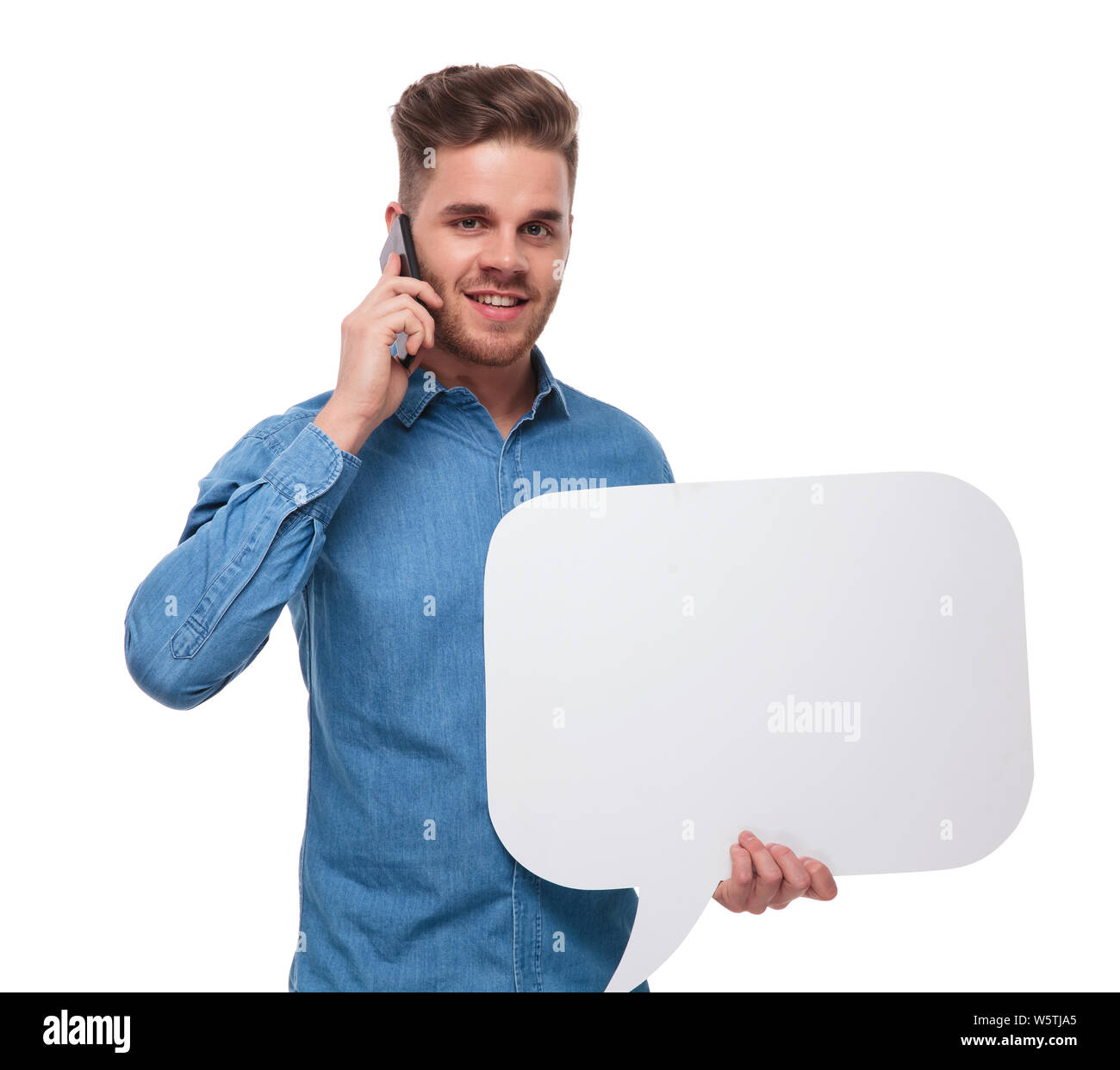 portrait of young casual man with speech bubble speaking on the phone ...