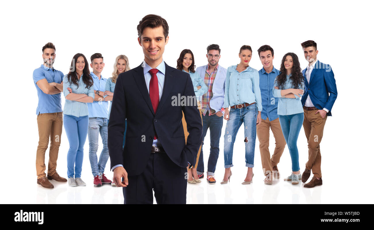 smiling team leader standing with his casual team behind on white ...
