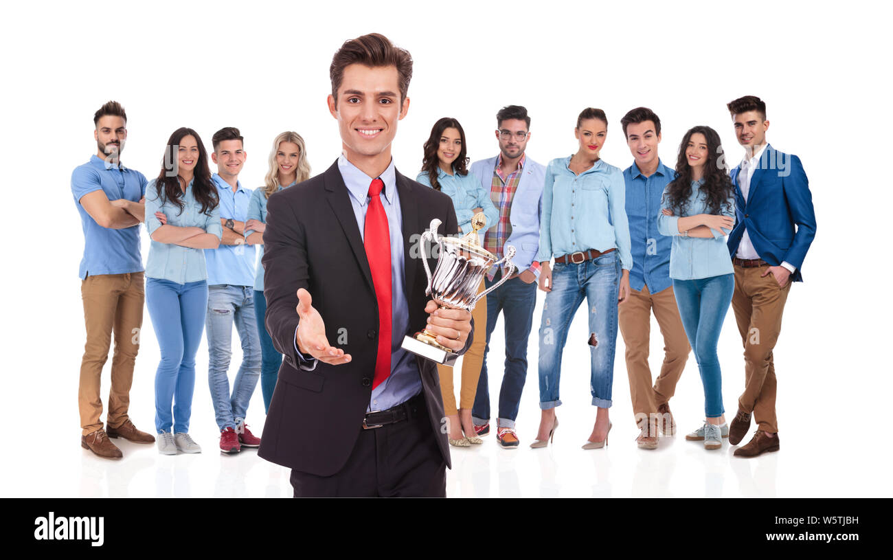 businessman group leader with trophy greeting you with a handshake to ...