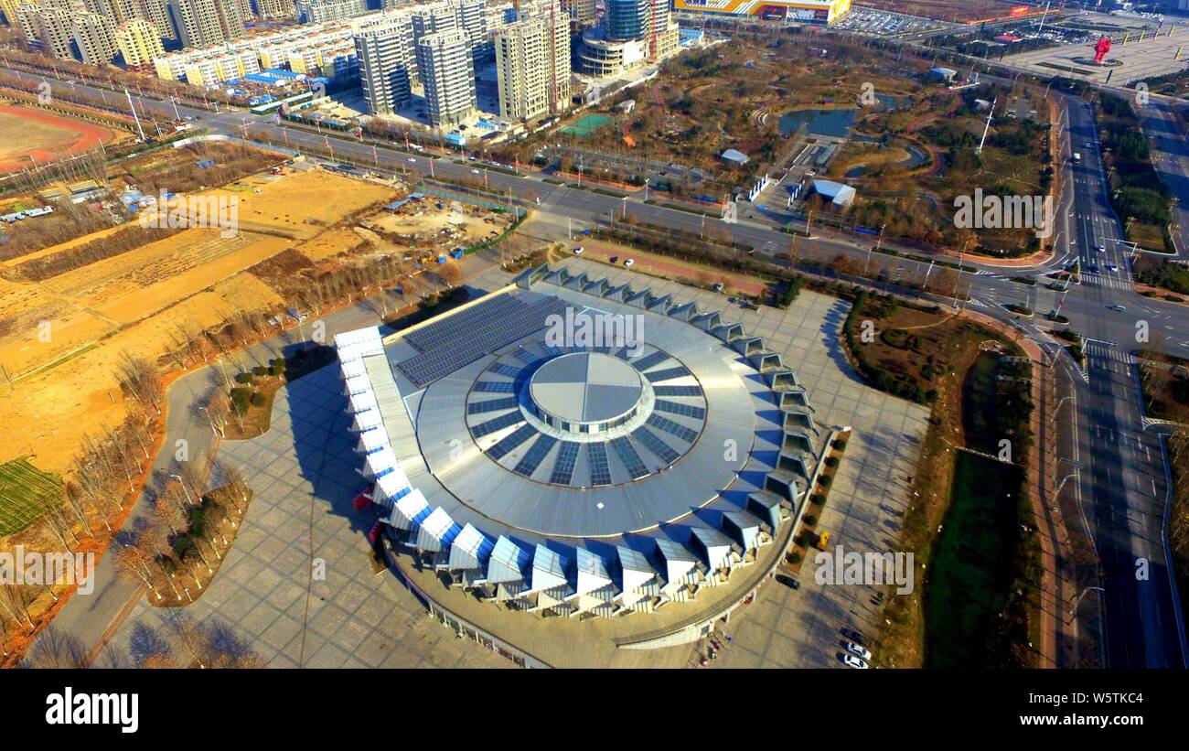 An aerial view of toilet lid-shaped building surrounded by 152 "paper ...