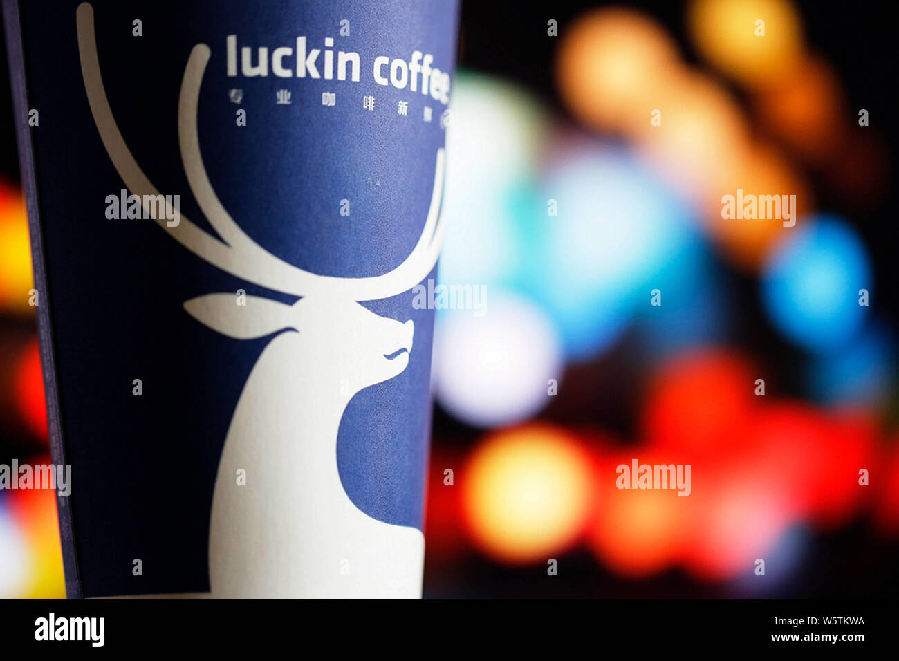 A customer shows a cup of Luckin Coffee at a store of China's new ...