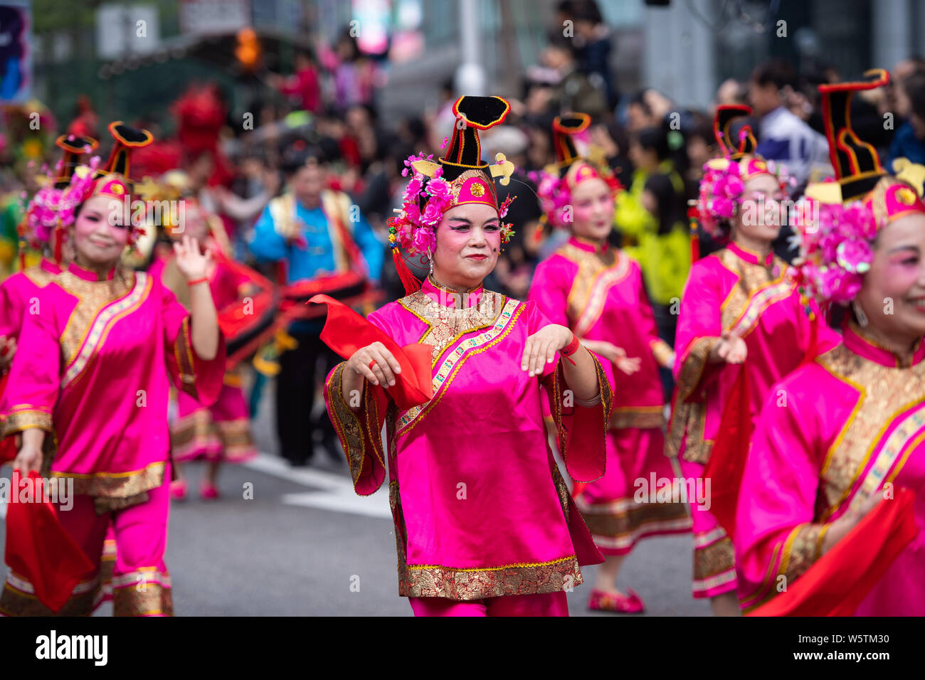 Performers take part in an international parade marking the 19th ...