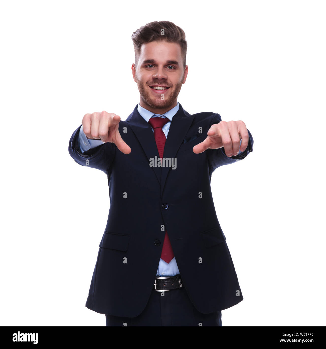 portrait of joyful elegant businessman pointing fingers from both hands ...