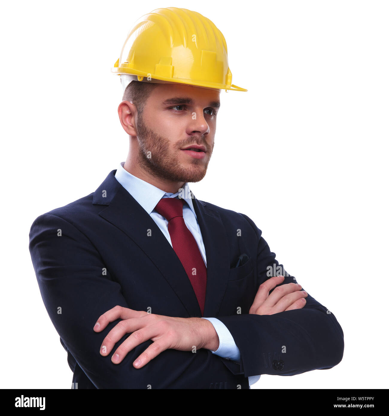 portrait of confident engineer boss looking to side while standing on ...